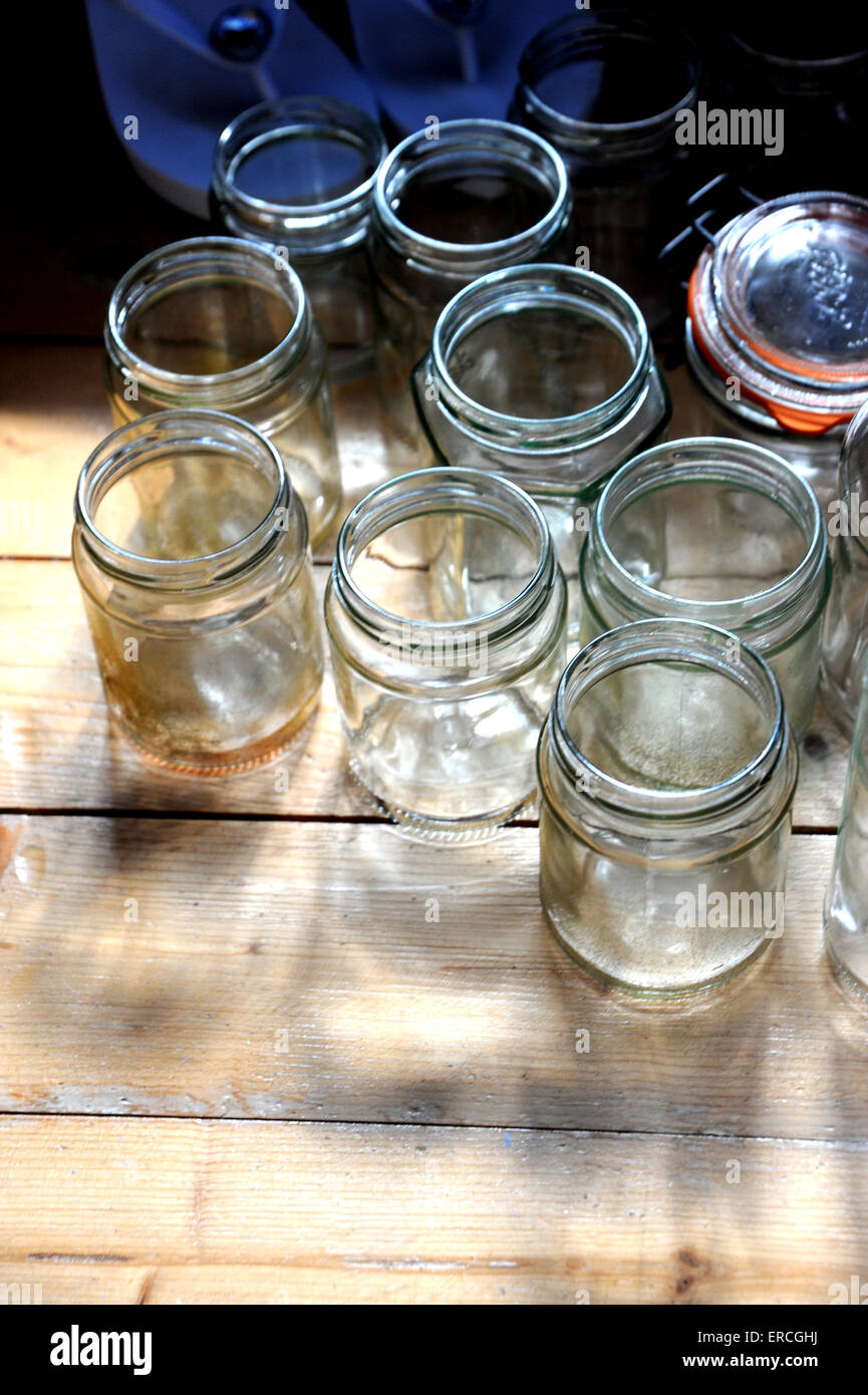 Empty glass jam storage jars with sun glinting through Stock Photo - Alamy