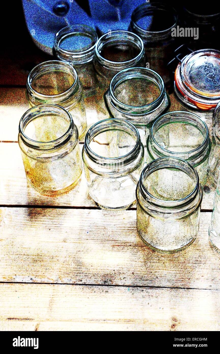 Empty glass jam storage jars with sun glinting through Stock Photo - Alamy