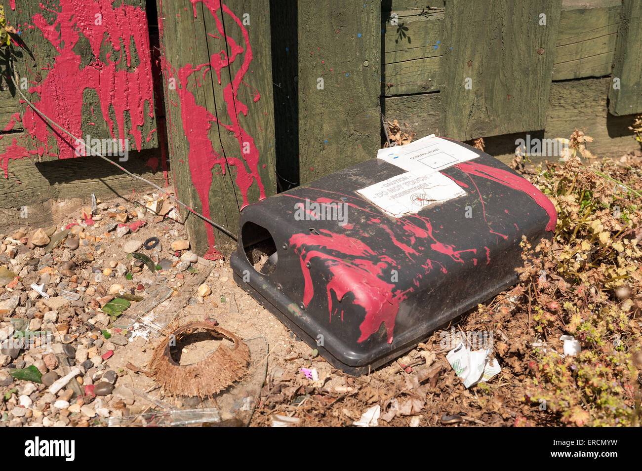 Vermin rat or rodent trap placed on side wall in local rat run route in ...