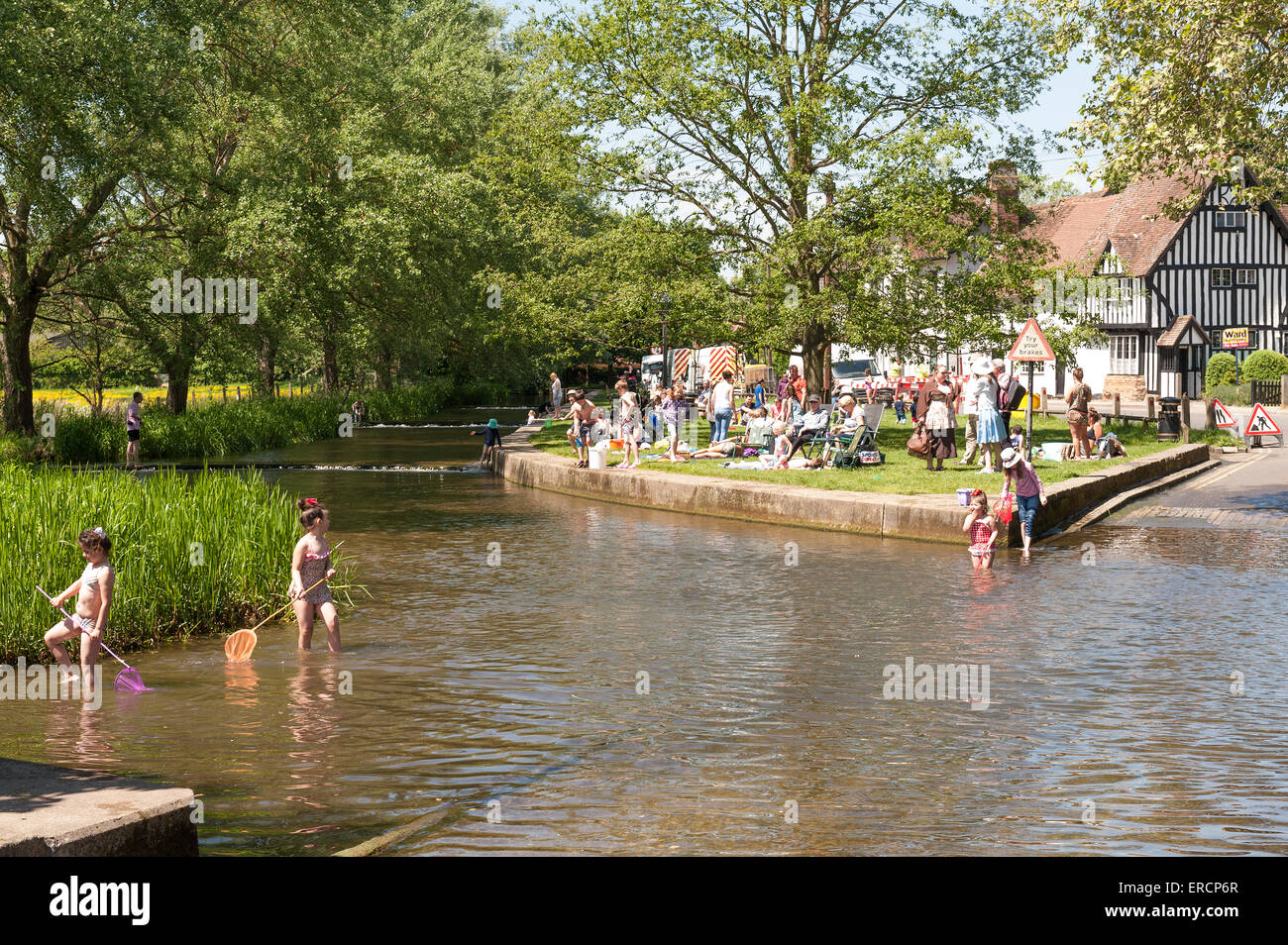 Lazy summer holidays half term as lots parents children paddle and fish ...