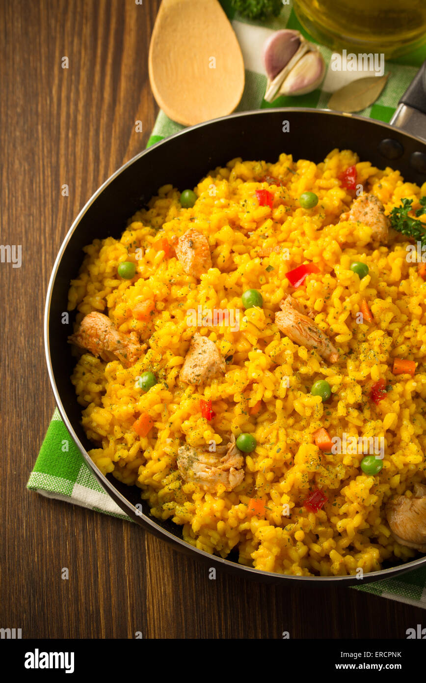 frying pan full of rice on wooden background Stock Photo - Alamy