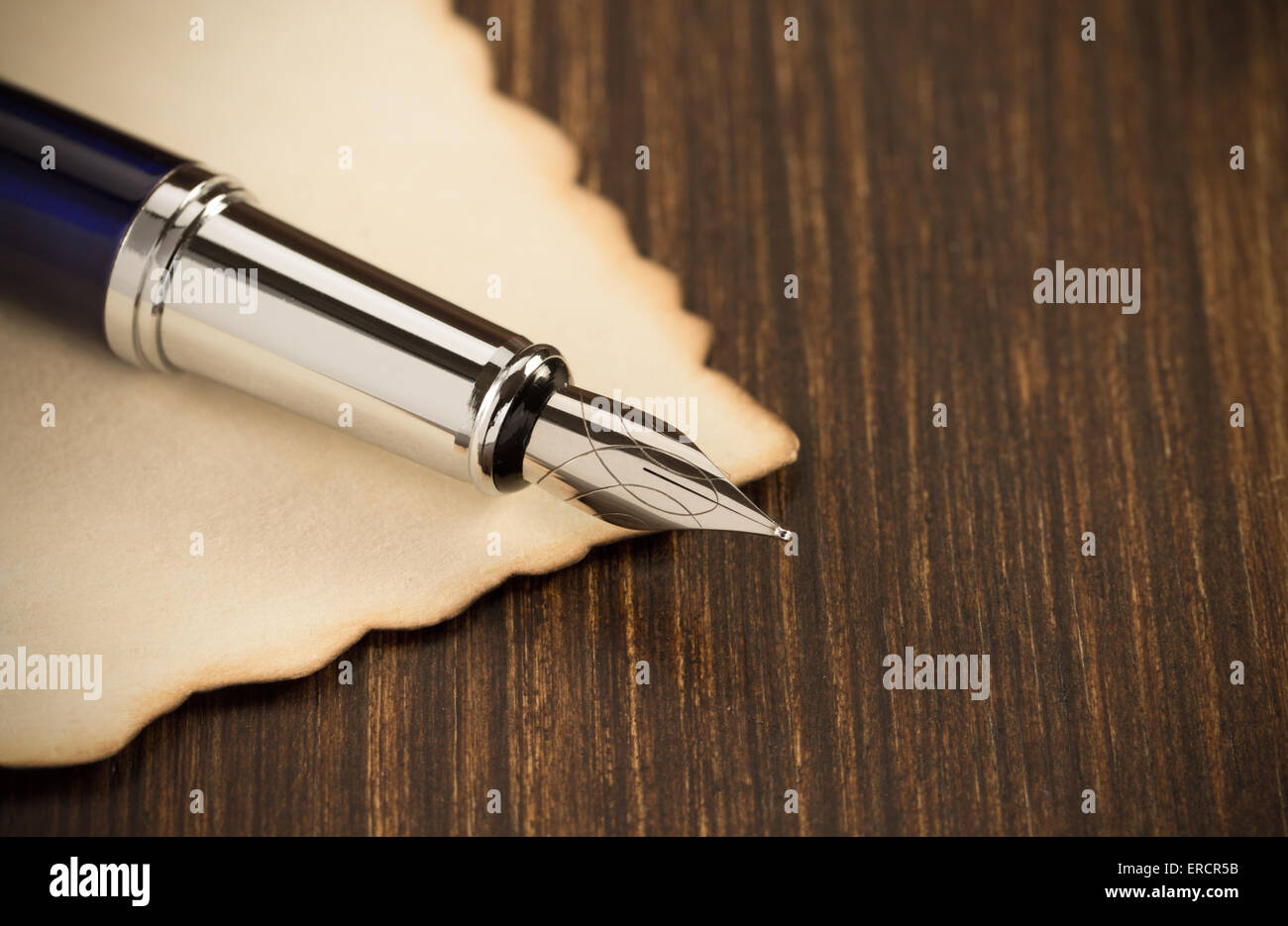ink pen and paper parchment on wooden background Stock Photo - Alamy