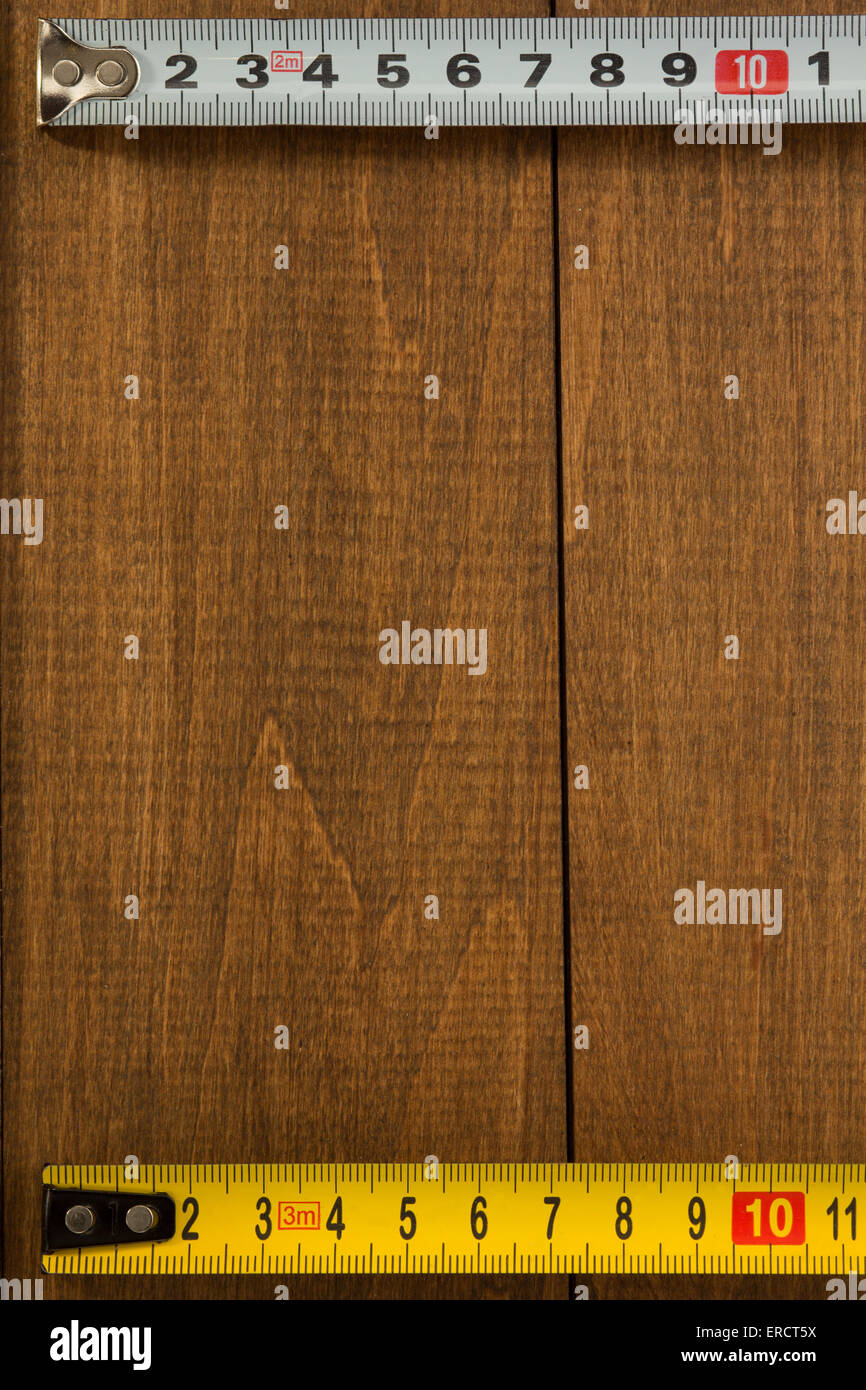 tape measure tool on wooden texture Stock Photo - Alamy