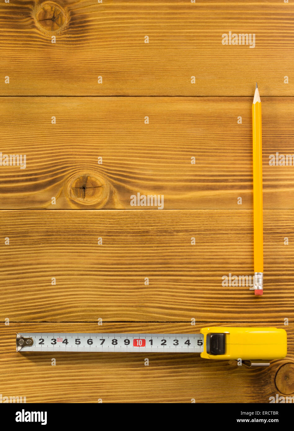 tape measure and pencil on wooden texture Stock Photo - Alamy
