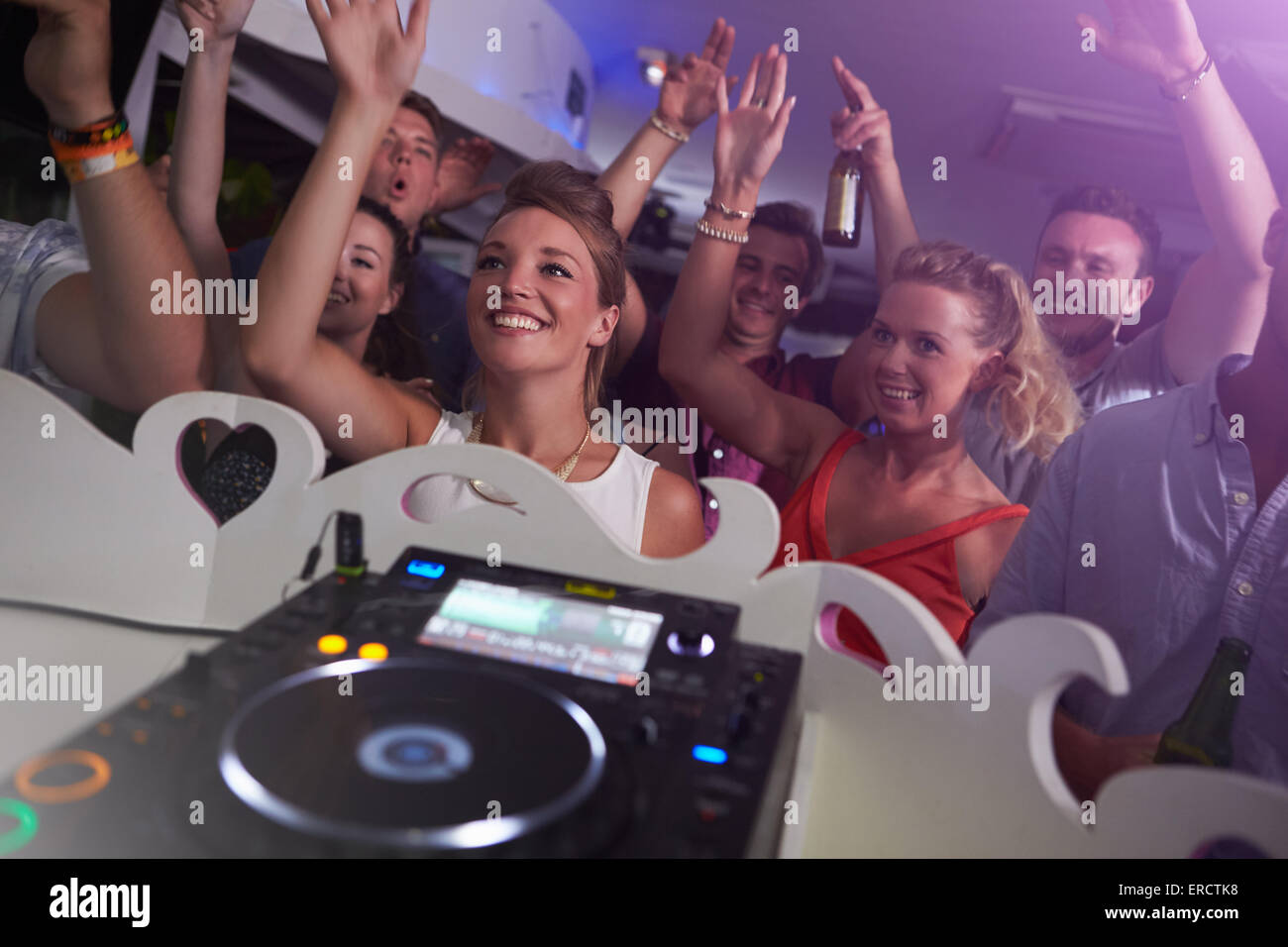 People Dancing In Nightclub With DJ In Foreground Stock Photo - Alamy