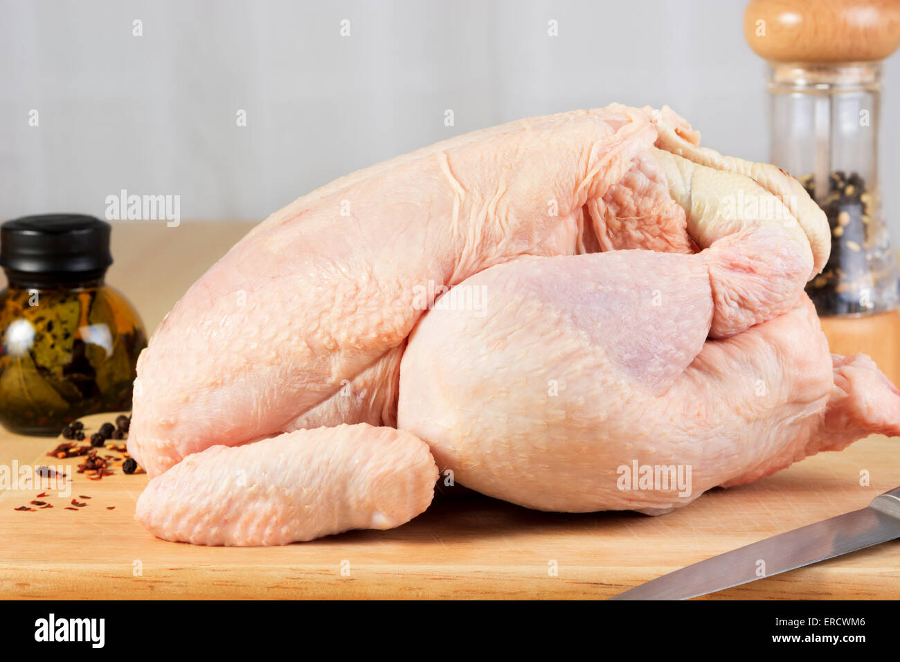 Whole raw chicken on a wooden plank Stock Photo - Alamy