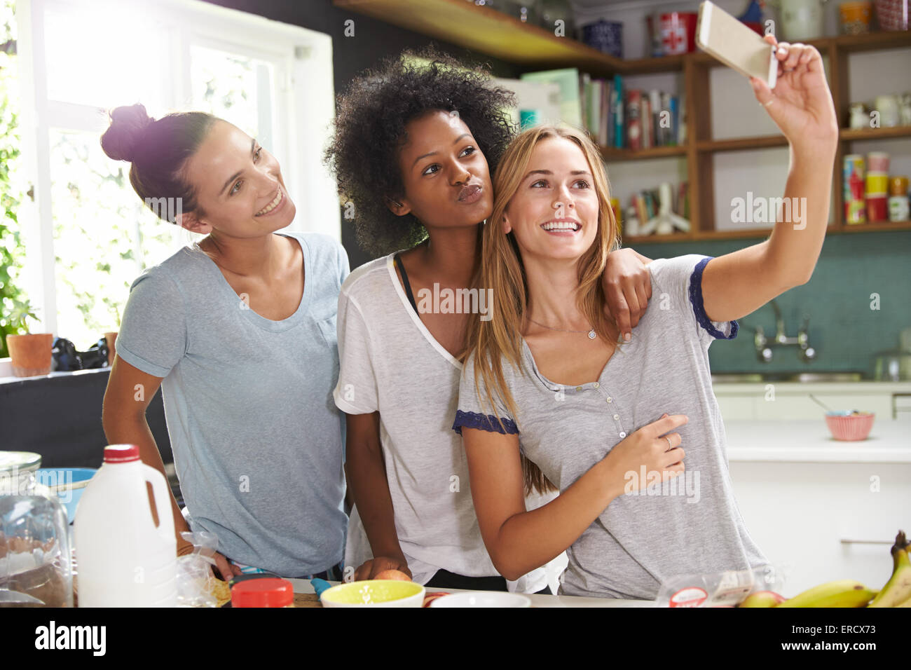 Female friends making breakfast whilst hi-res stock photography and ...
