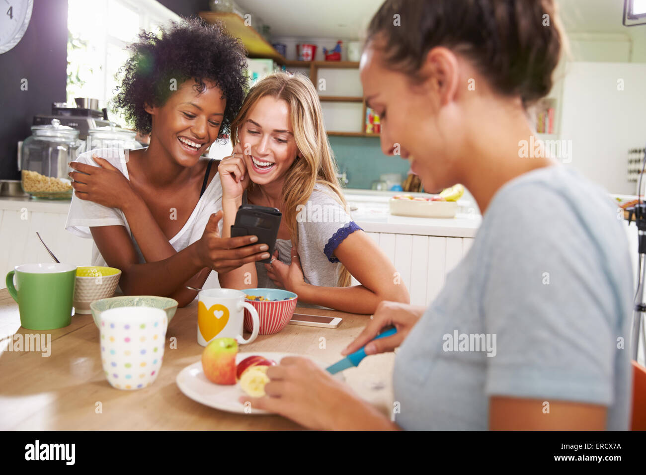 Female friends making breakfast whilst hi-res stock photography and ...