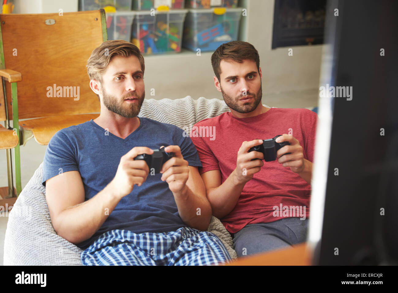 Two Male Friends In Pajamas Playing Video Game Together Stock Photo - Alamy