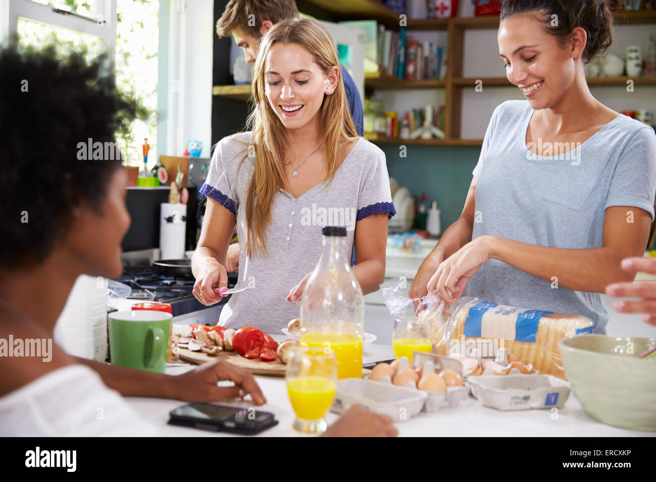 Group Of Friends Cooking Breakfast In Kitchen Together Stock Photo - Alamy