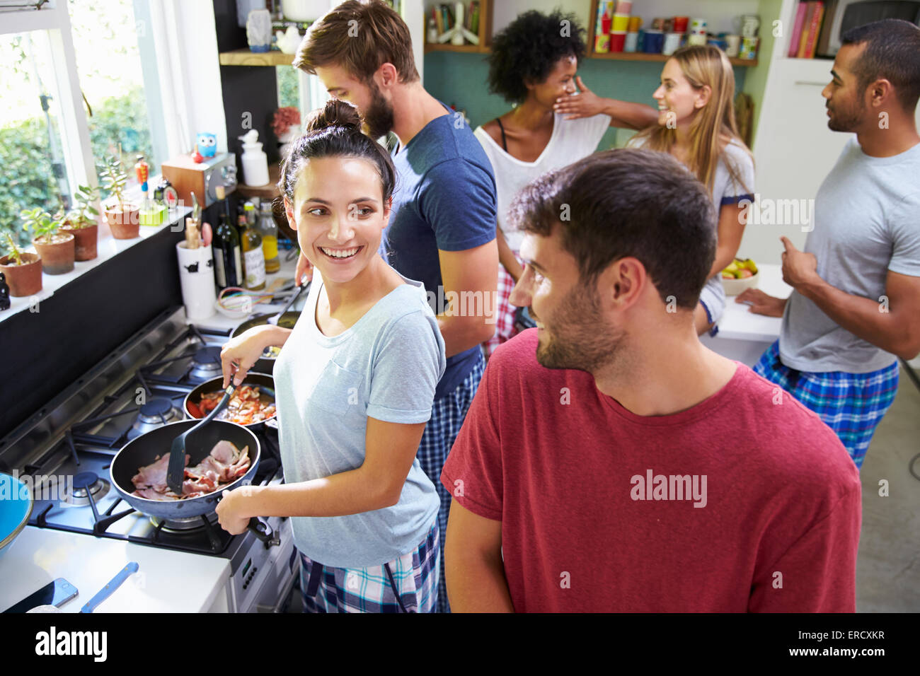 Group Of Friends Cooking Breakfast In Kitchen Together Stock Photo - Alamy