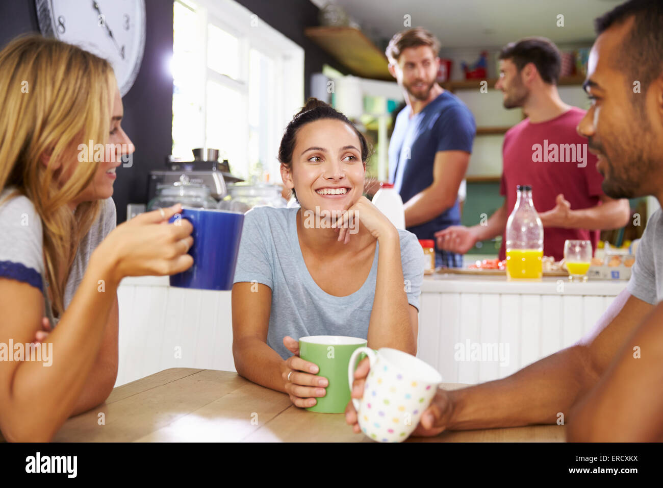 Group Of Friends Enjoying Breakfast In Kitchen Together Stock Photo - Alamy