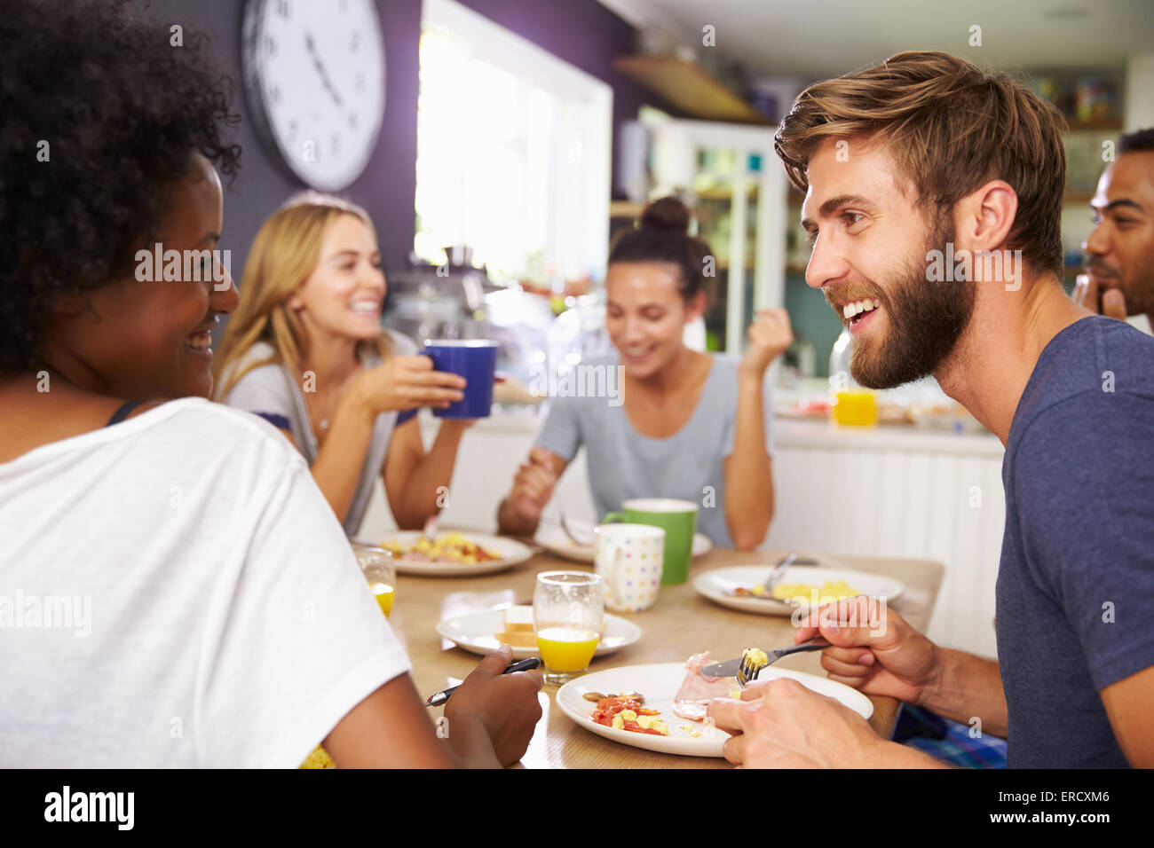 Group Of Friends Enjoying Breakfast In Kitchen Together Stock Photo - Alamy