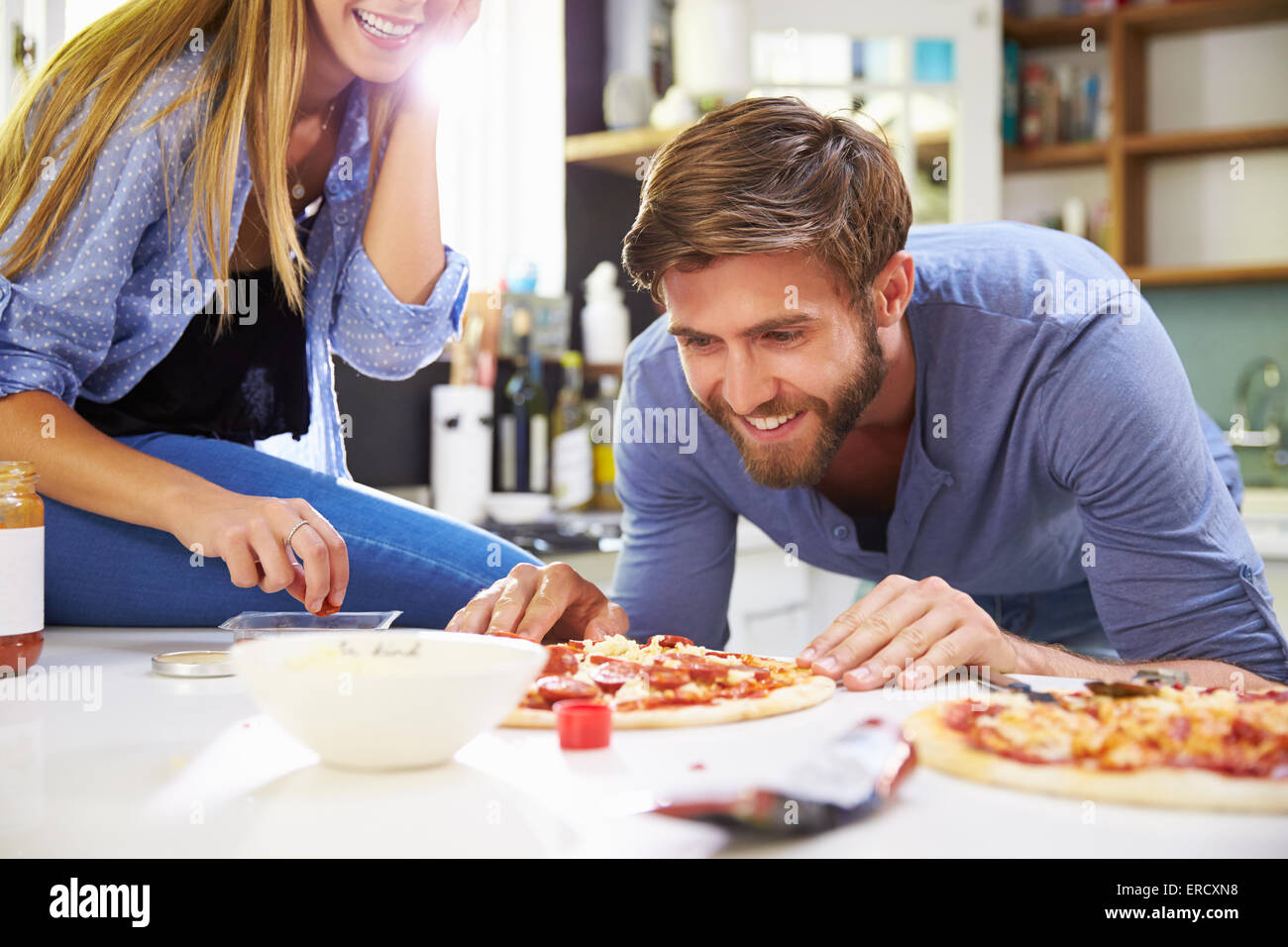 Young Couple Making Pizza In Kitchen Together Stock Photo - Alamy