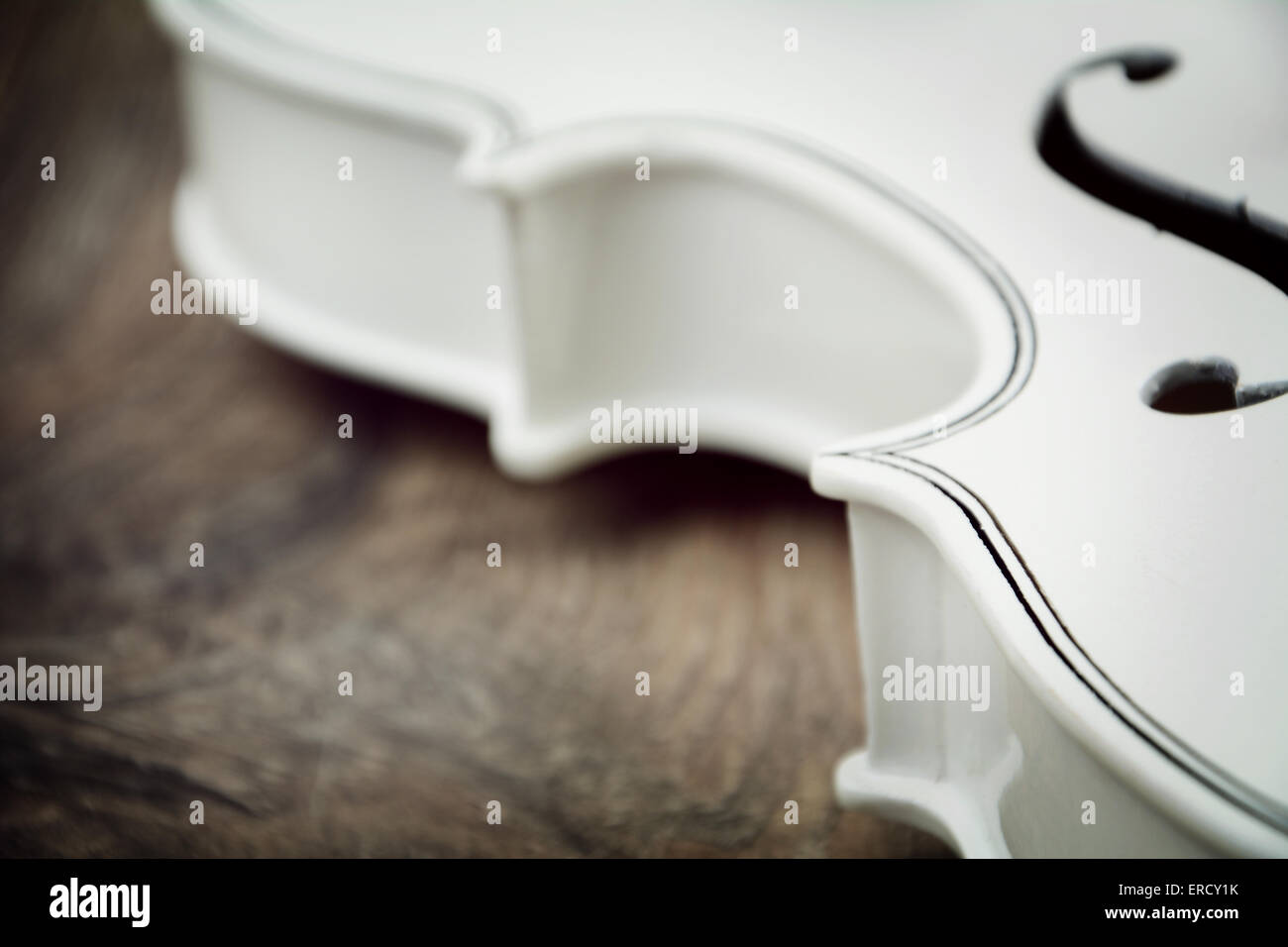 Beautiful white violin on the wooden table Stock Photo - Alamy