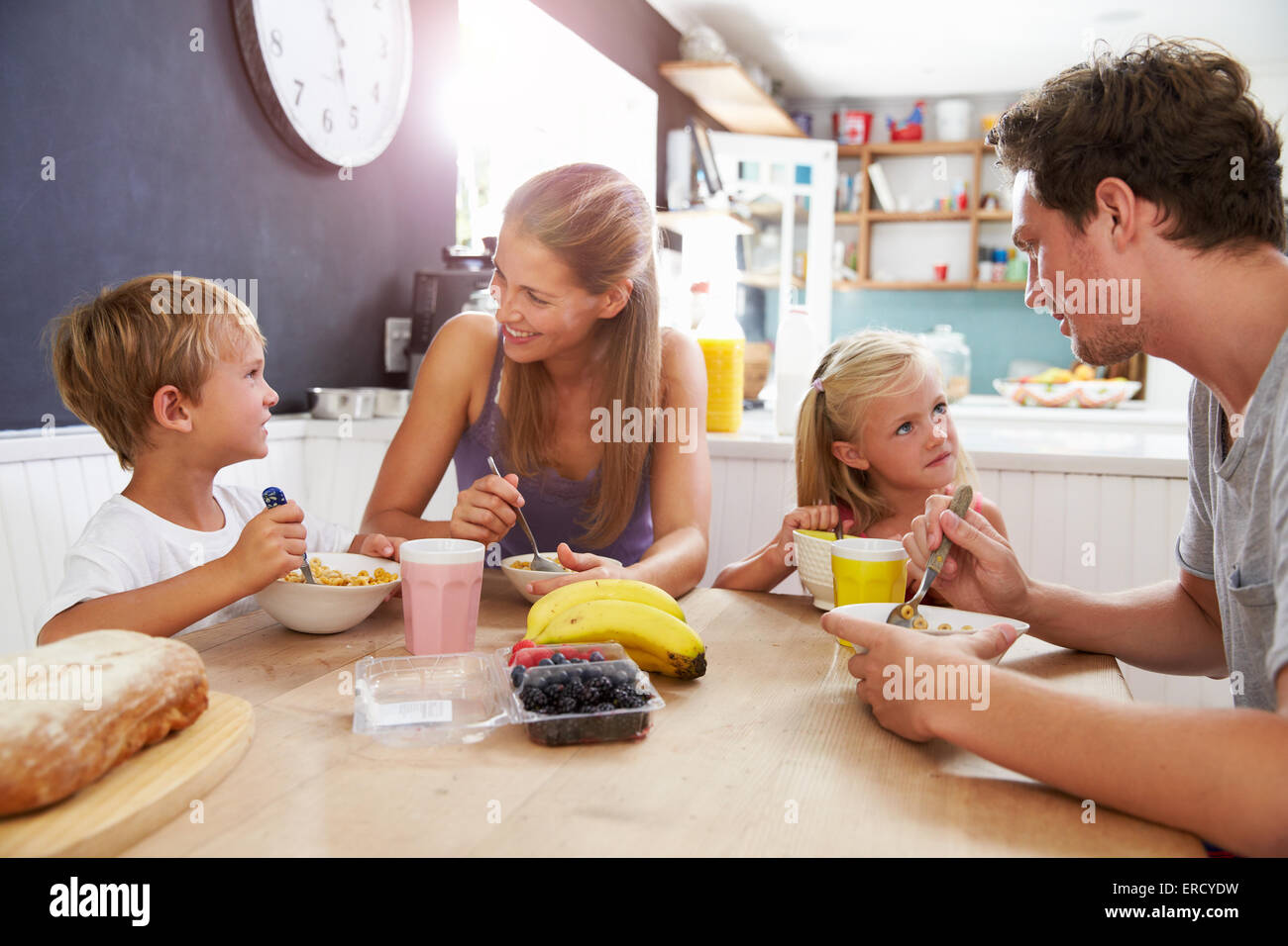 Family Eating Breakfast At Kitchen Table Stock Photo - Alamy