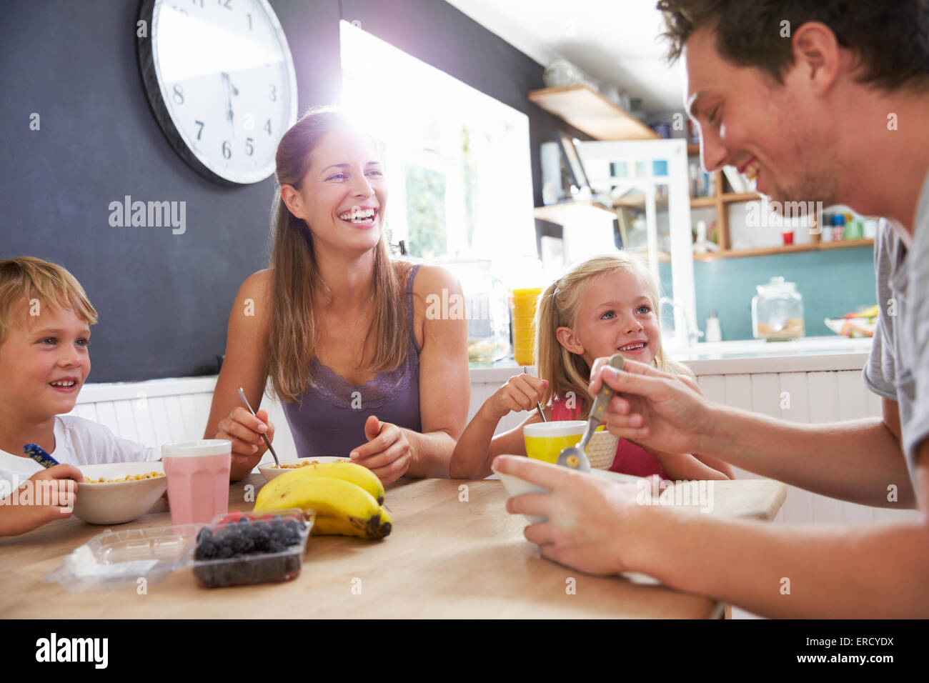 Family Eating Breakfast At Kitchen Table Stock Photo - Alamy