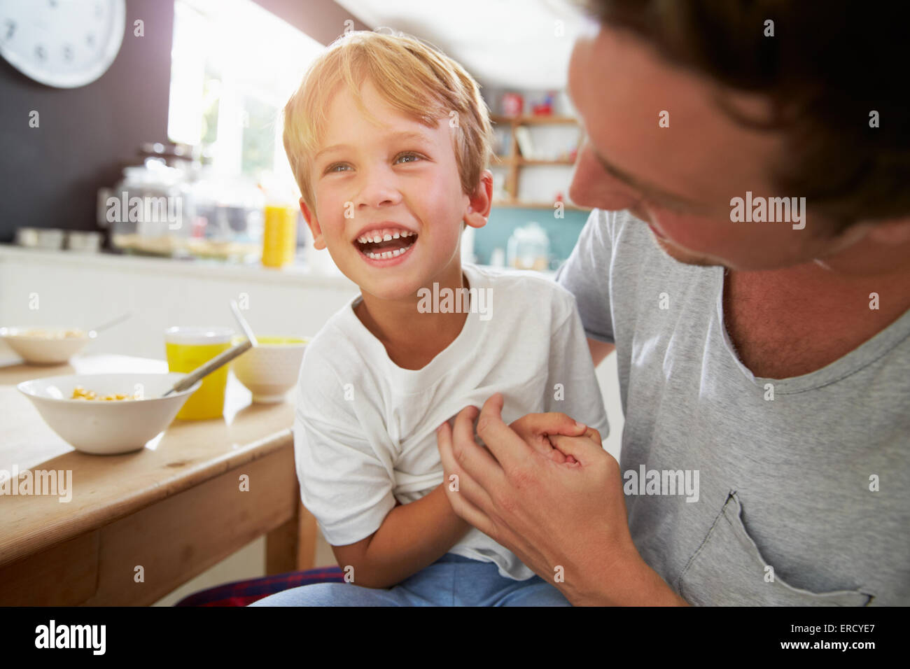 Father And Son Sitting At Breakfast Table Together Stock Photo - Alamy