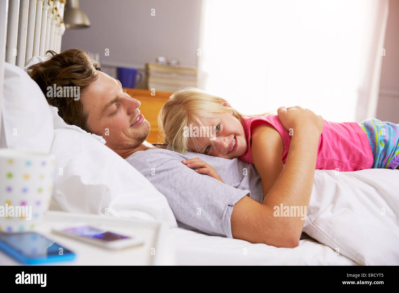 Father And Daughter Lying In Bed Together Stock Photo - Alamy