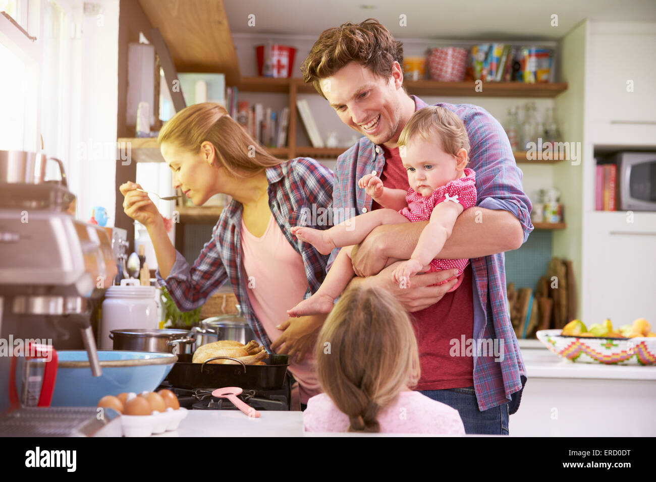 Family Cooking Meal In Kitchen Together Stock Photo - Alamy