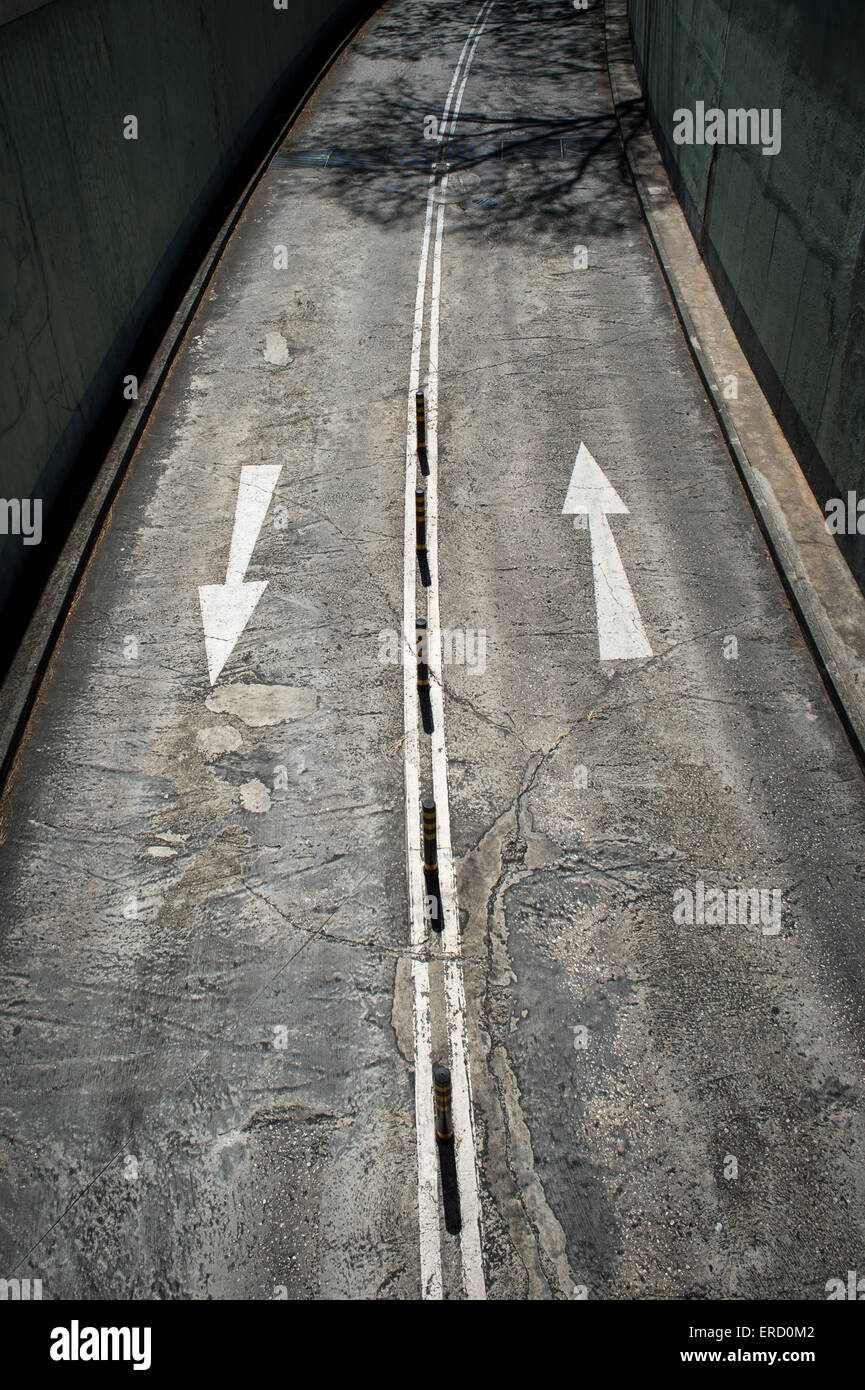 white arrows painted on a road in either direction viewed from above ...