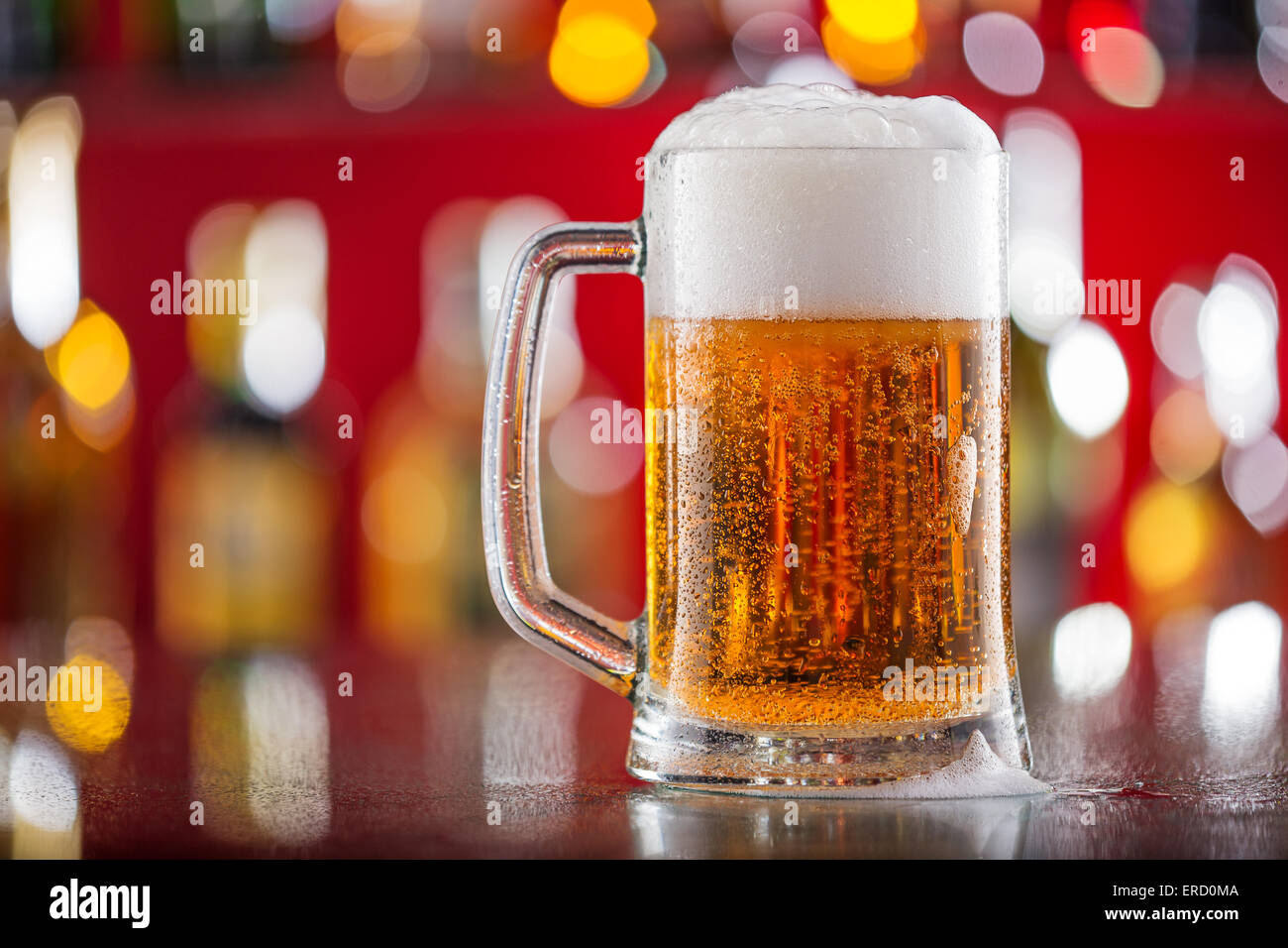 Bottle of beer with glass on bar desk, close-up Stock Photo - Alamy
