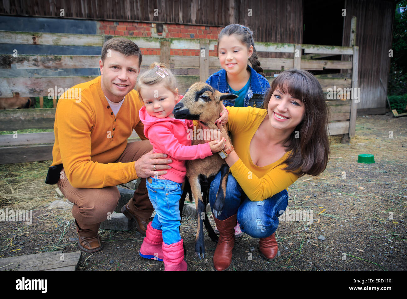 a farm family with a sheep in front of the farm Stock Photo - Alamy