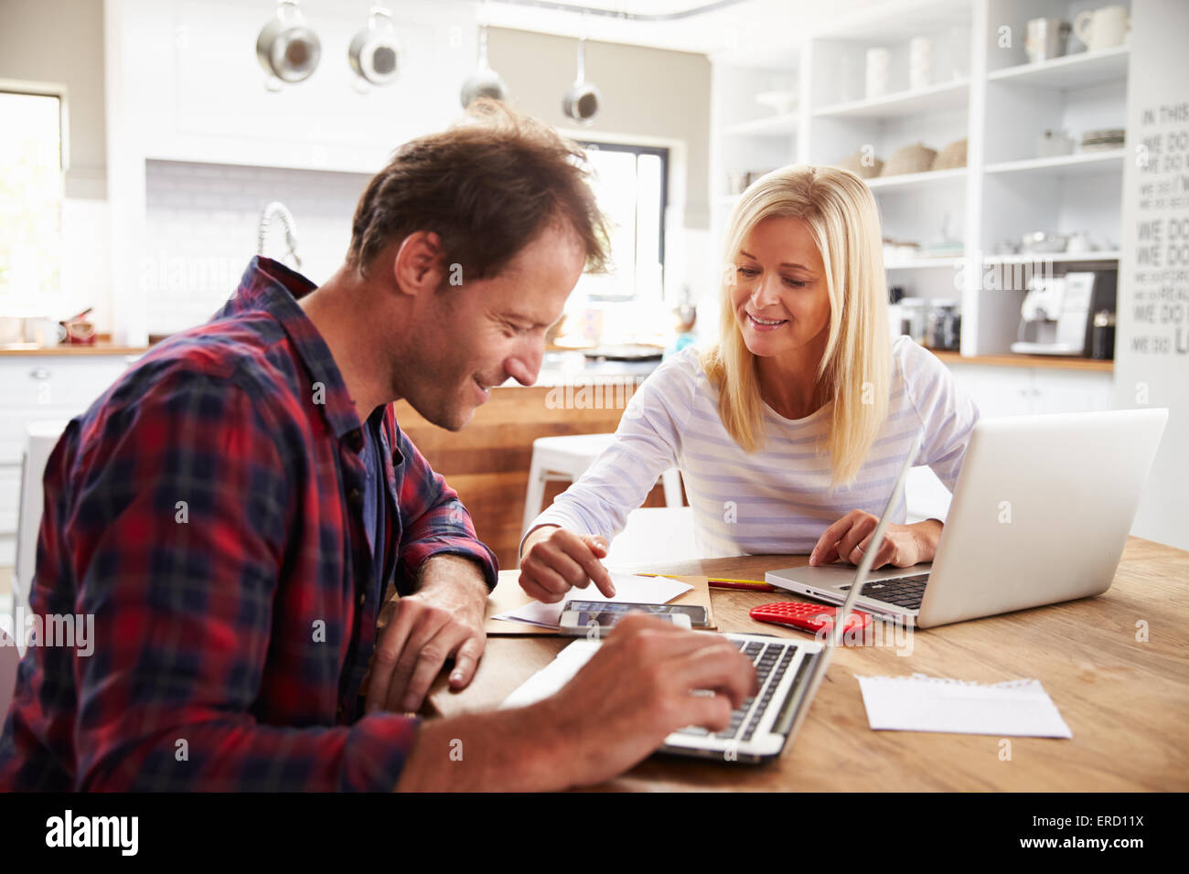 Man and woman working together at home Stock Photo - Alamy