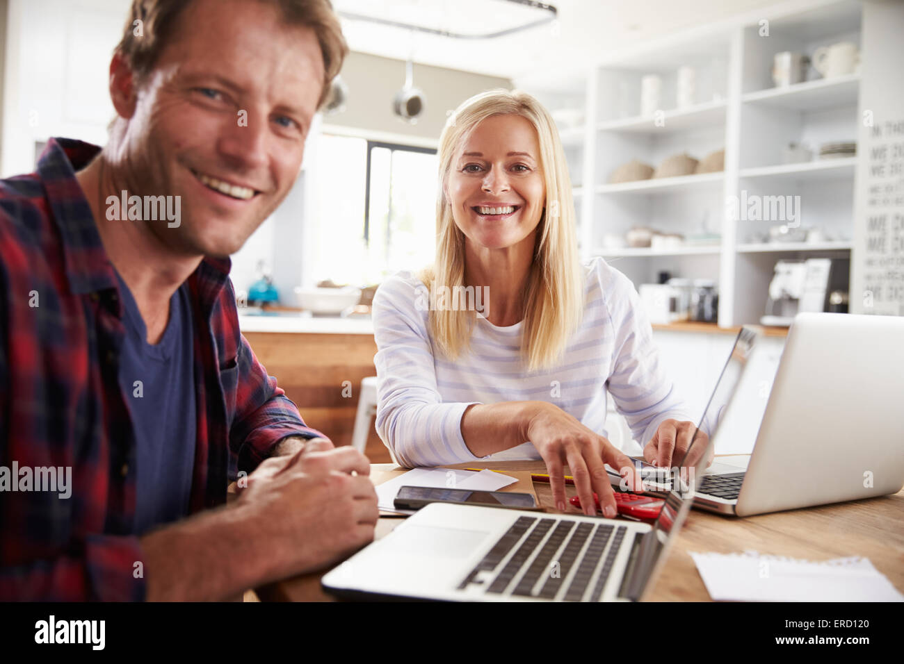 Man and woman working together at home Stock Photo - Alamy