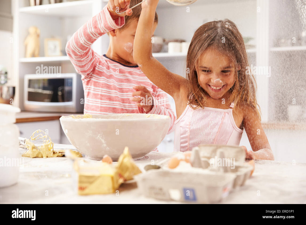 Two children having fun baking in the kitchen Stock Photo - Alamy