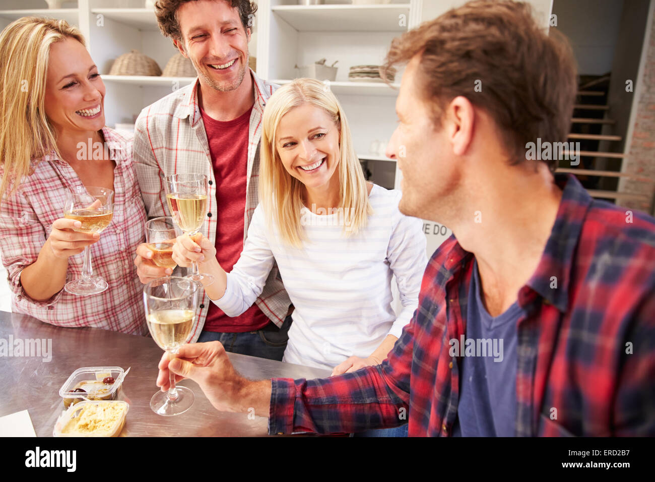 Four friends celebrating at home Stock Photo - Alamy
