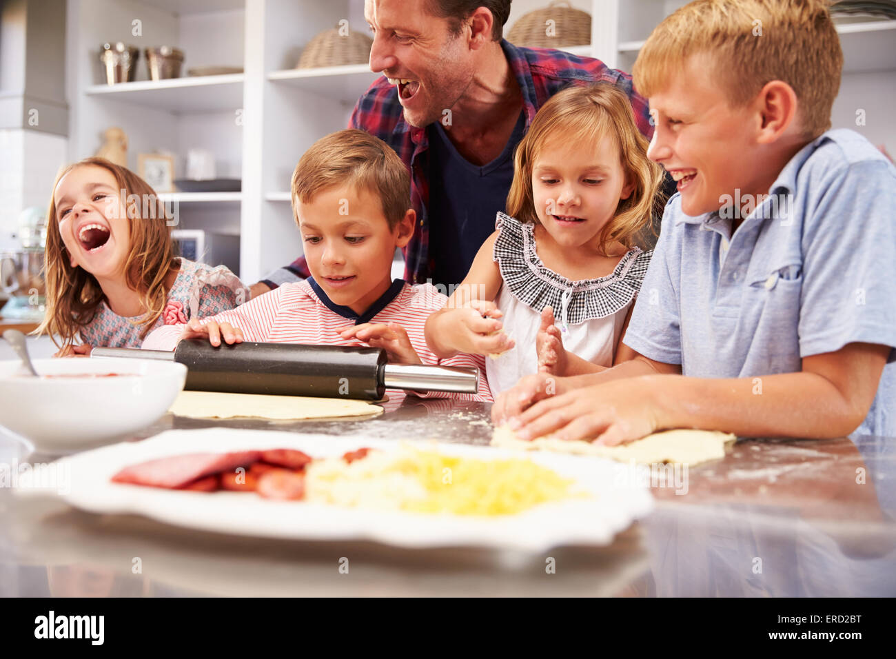 Father making pizza with his kids Stock Photo - Alamy