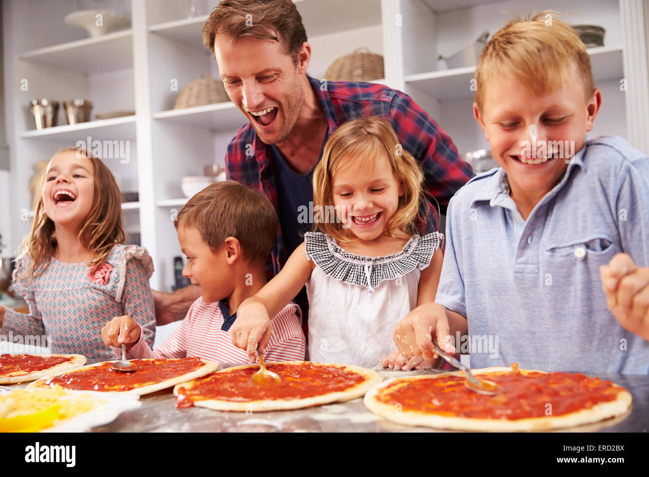 Father making pizza with his kids Stock Photo - Alamy