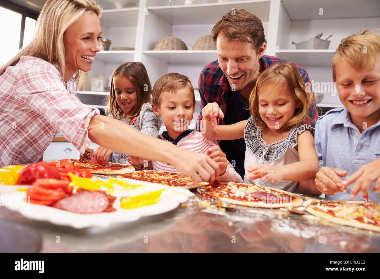 Family making pizza for dinner Stock Photo - Alamy