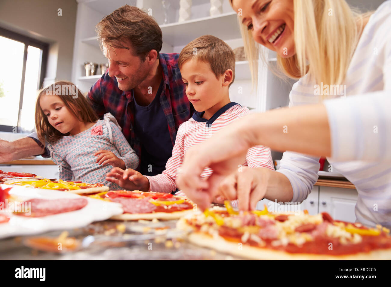 Family making pizza together Stock Photo - Alamy