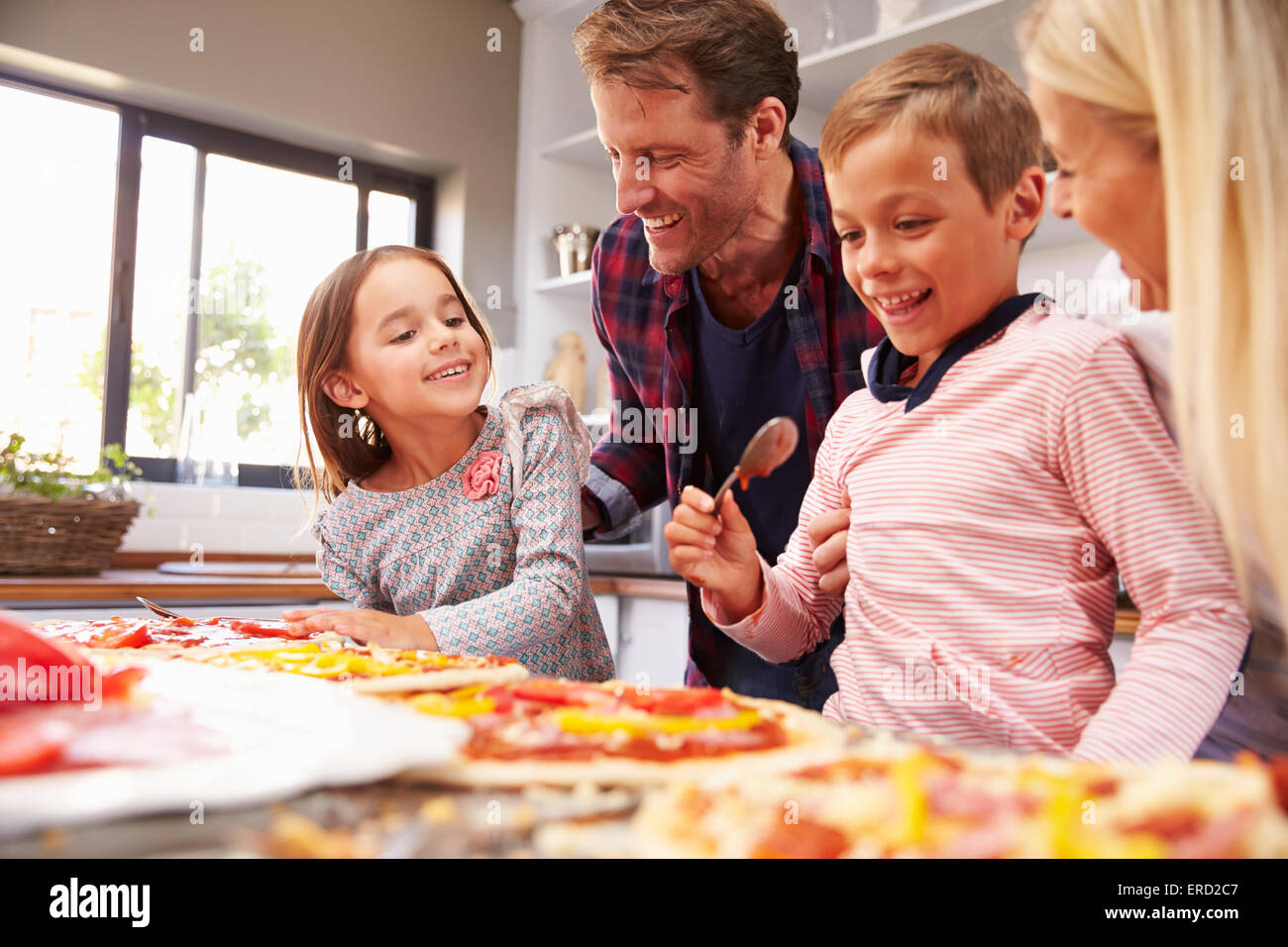Family making pizza together Stock Photo - Alamy