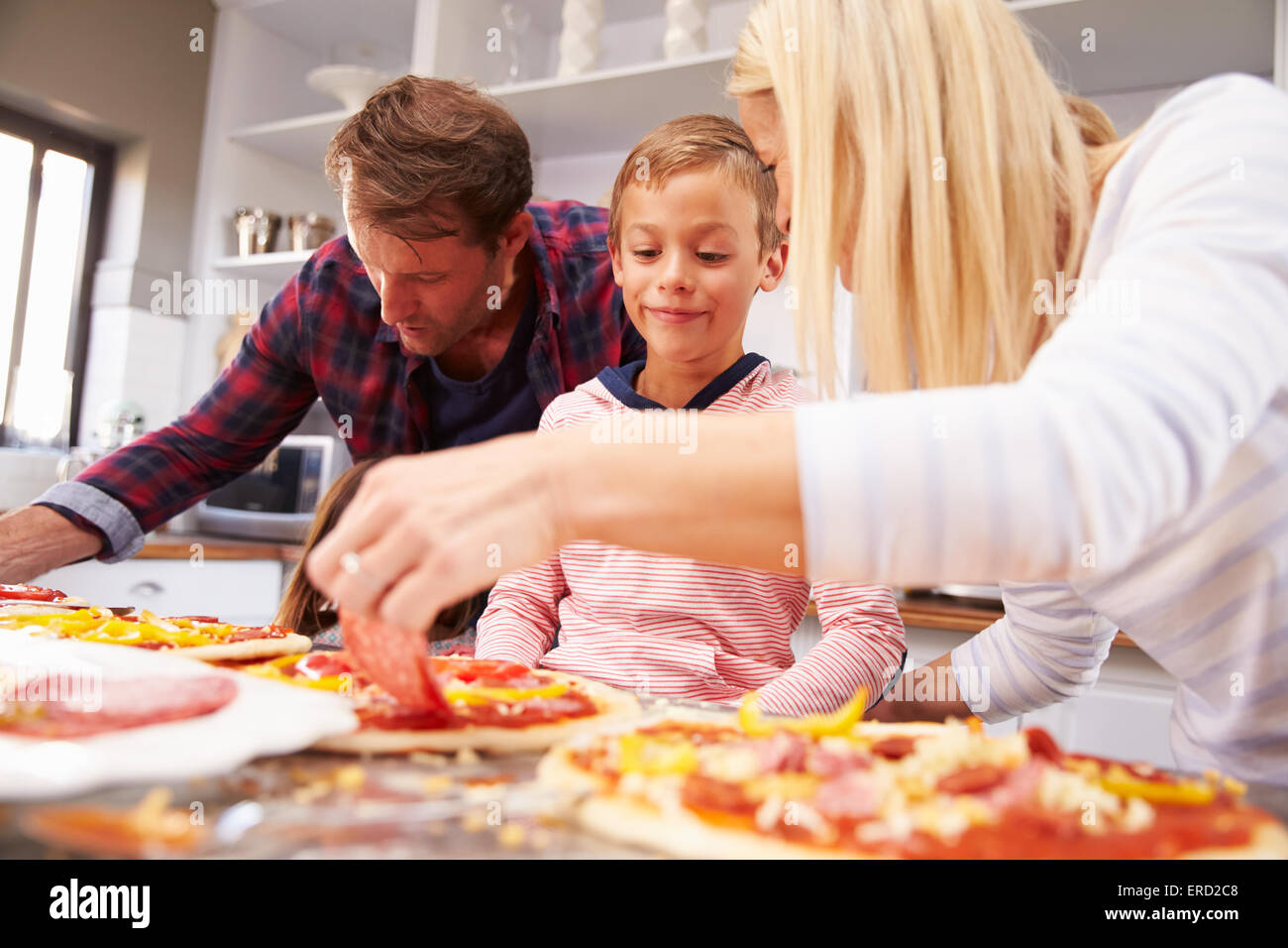 Family making pizza together Stock Photo - Alamy