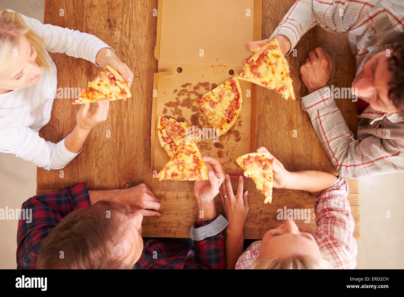 Friends sharing a pizza together, overhead view Stock Photo - Alamy