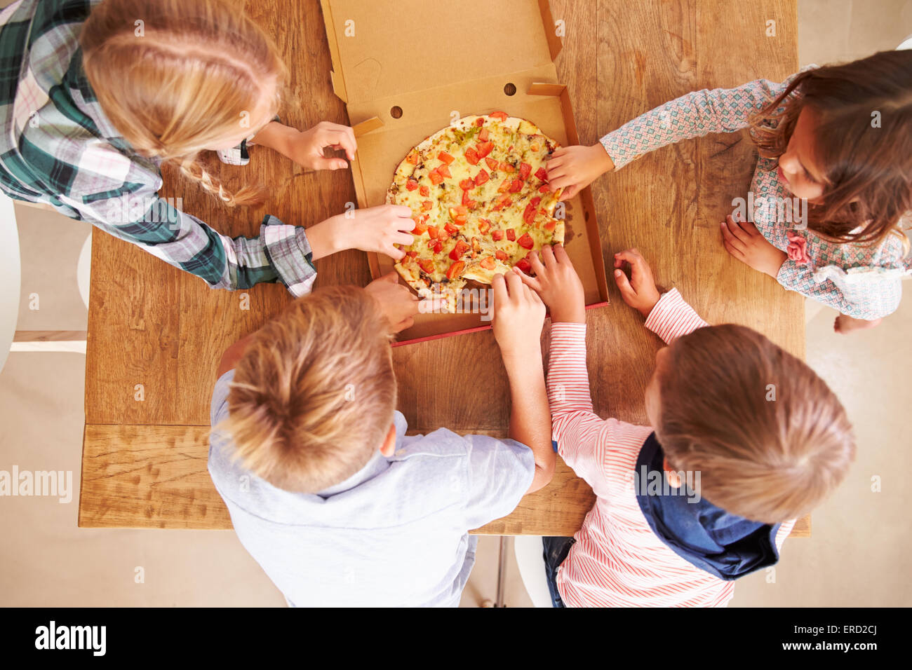 Children sharing a pizza together hi-res stock photography and images ...