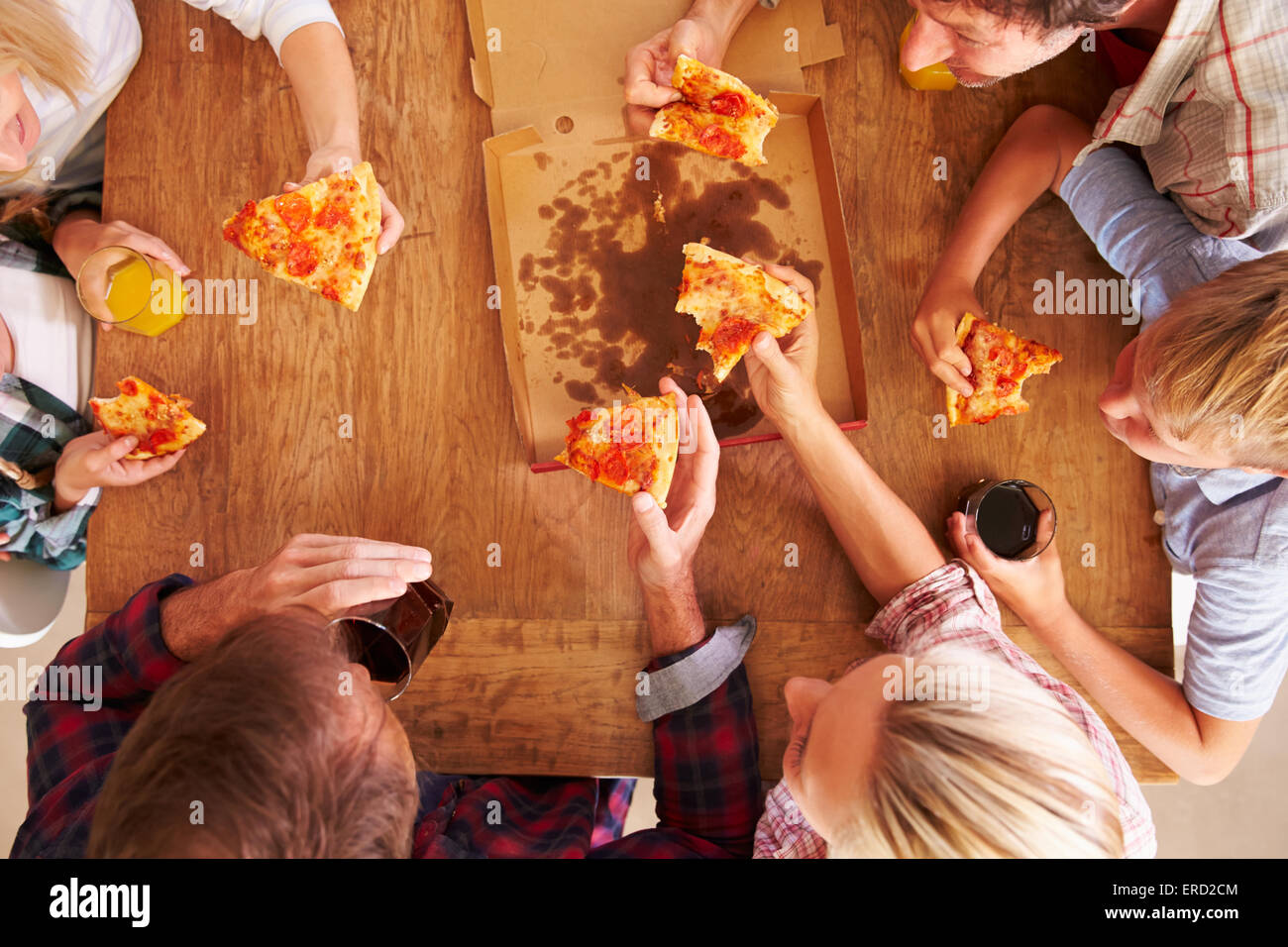 Friends sharing a pizza together, overhead view Stock Photo - Alamy
