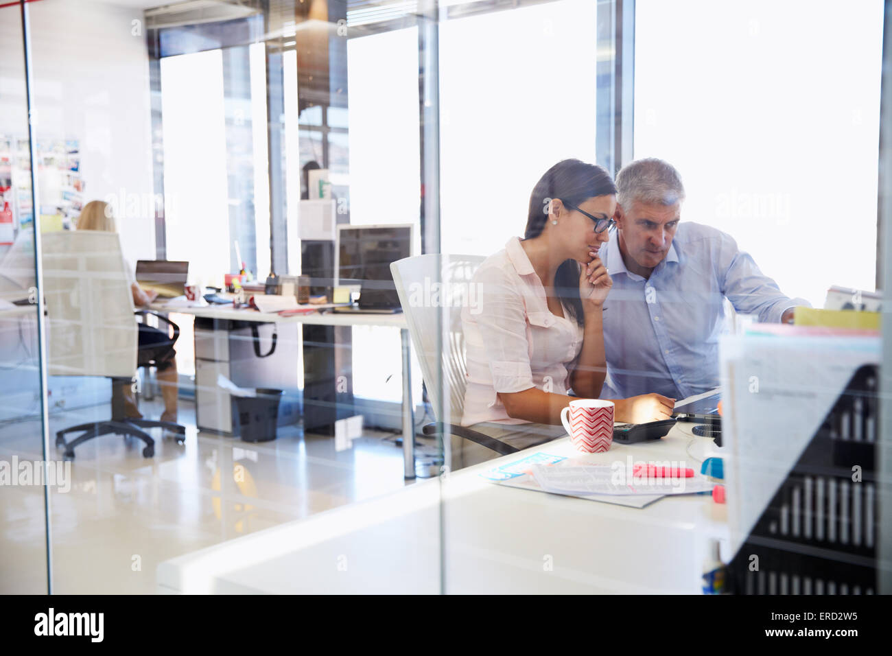 Office colleagues working together Stock Photo - Alamy