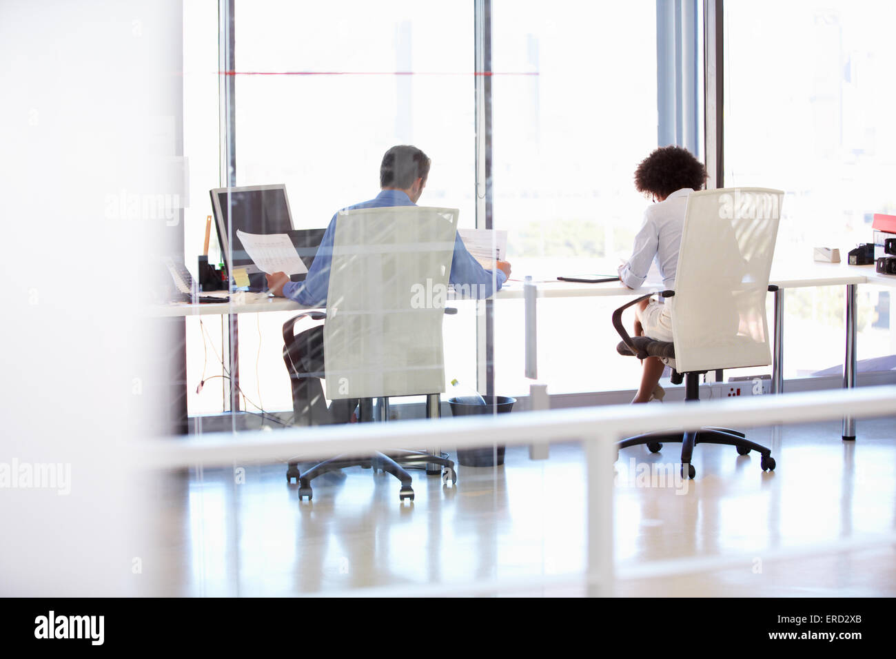 Two people working in a modern office Stock Photo - Alamy