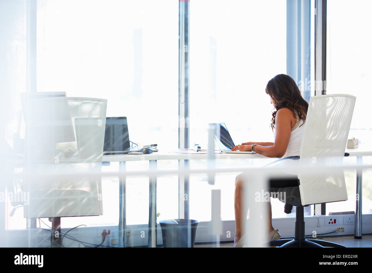 Woman working alone in an office Stock Photo - Alamy