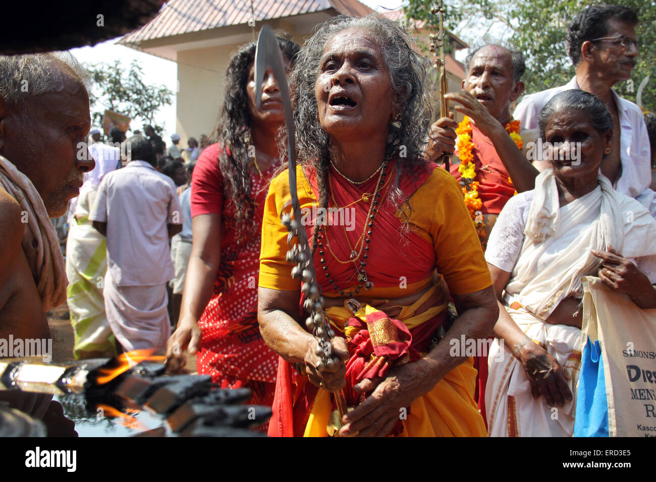 A Hindu Devotee Woman holding sword and praying at Kodungalloor Bharani ...