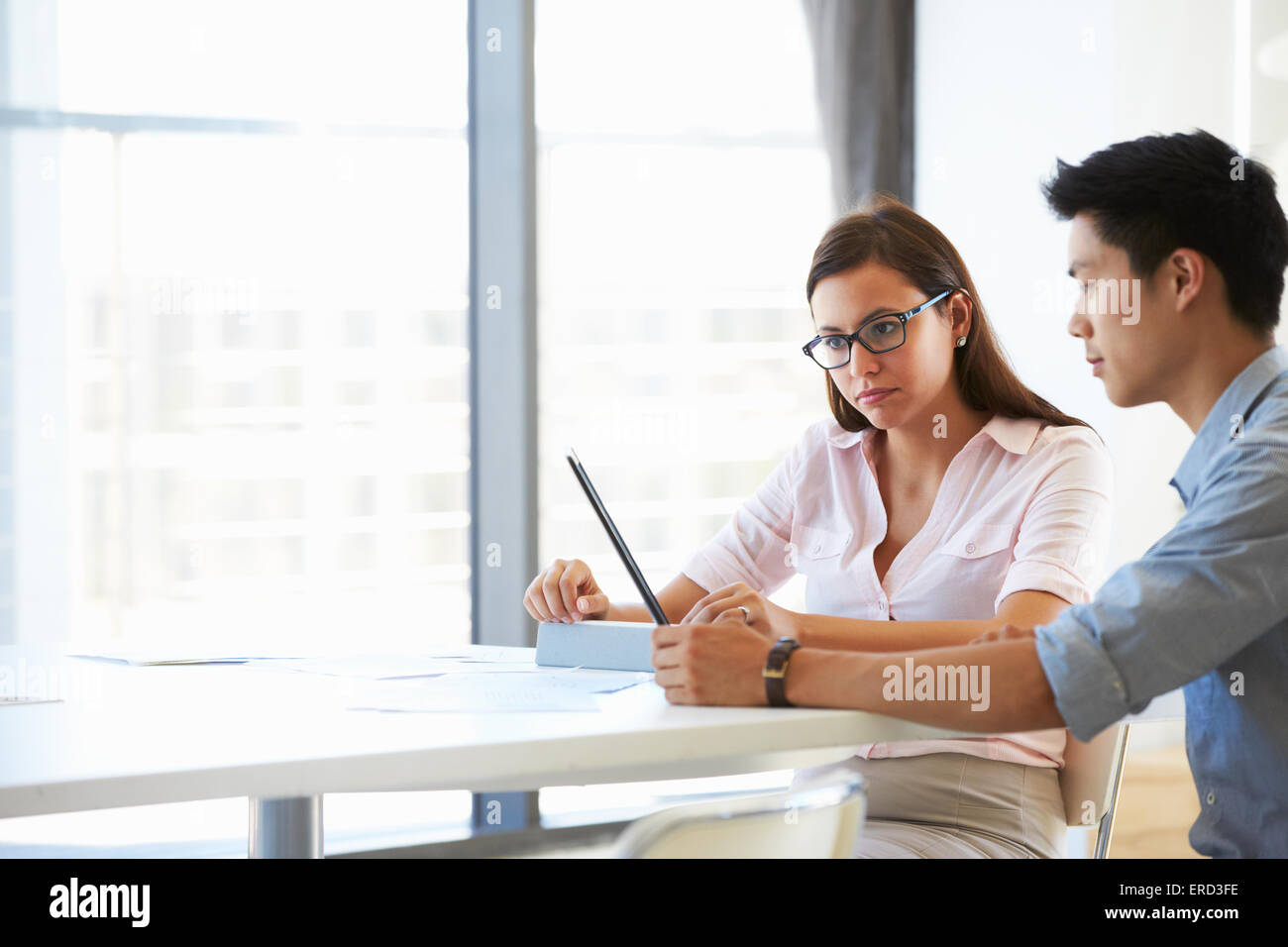 Two people working with digital tablet in empty meeting room Stock ...