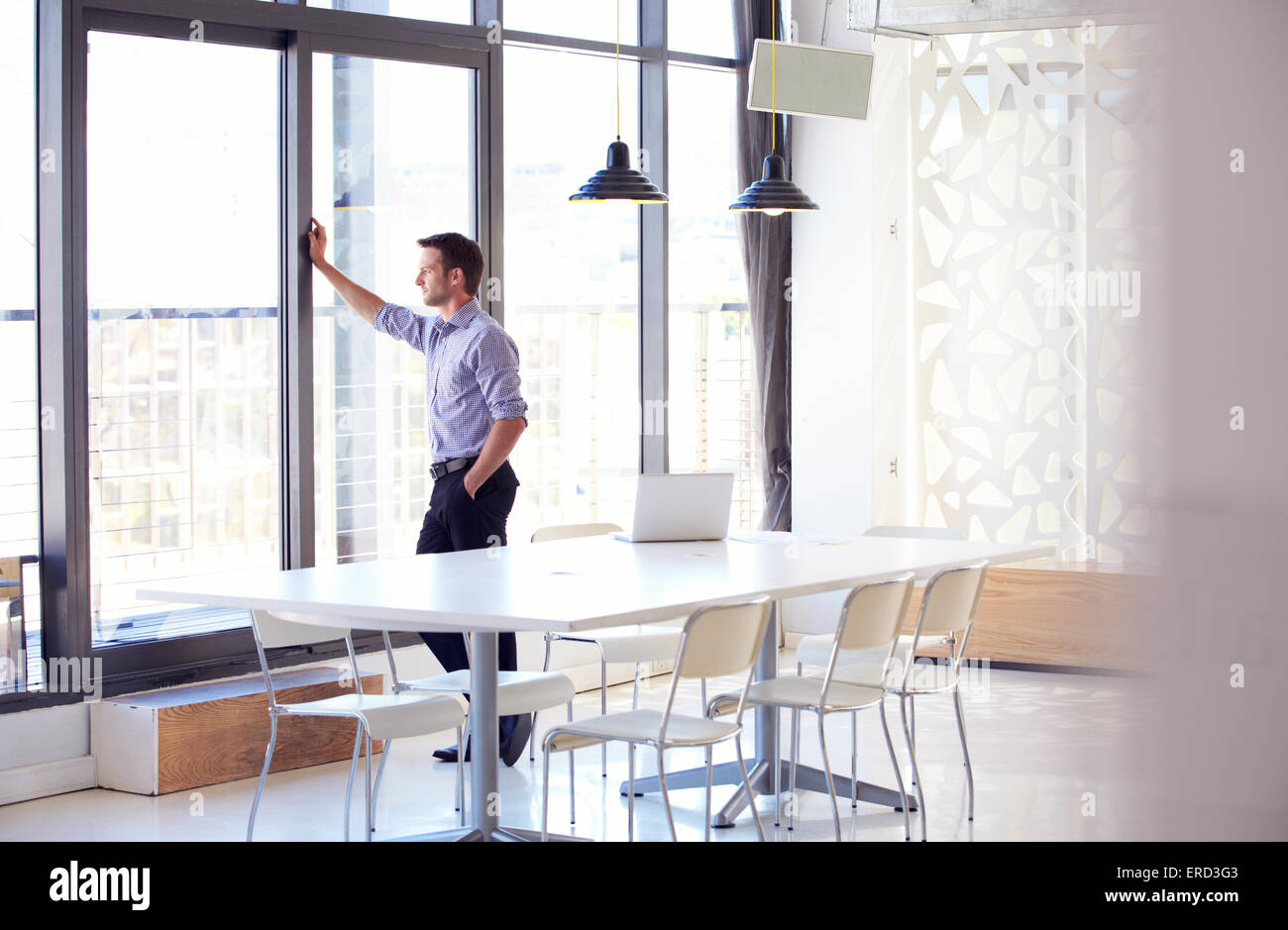 Young man in empty meeting room Stock Photo - Alamy