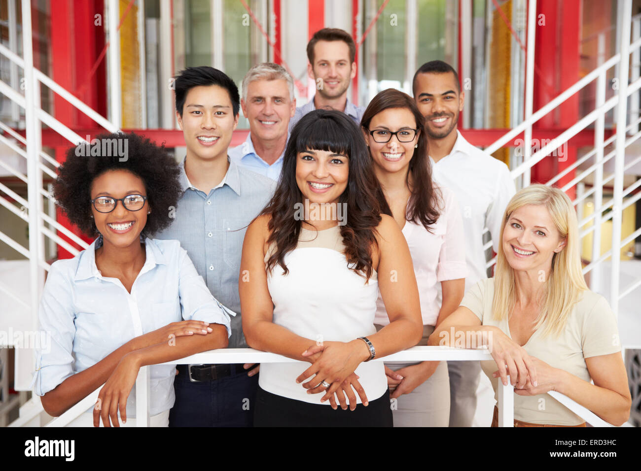 Group of work colleagues standing in an office lobby Stock Photo - Alamy