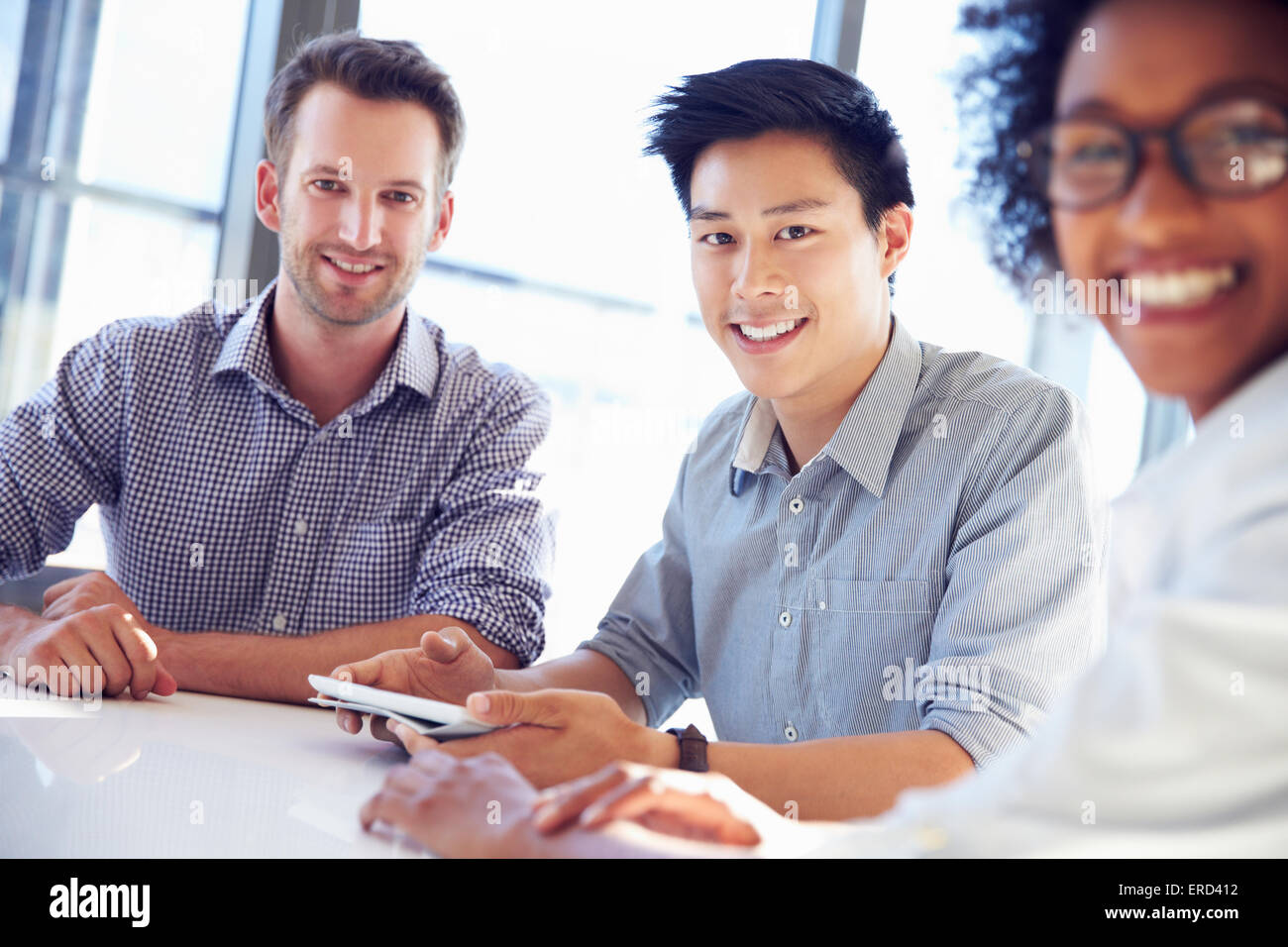 Three business professionals working together Stock Photo - Alamy