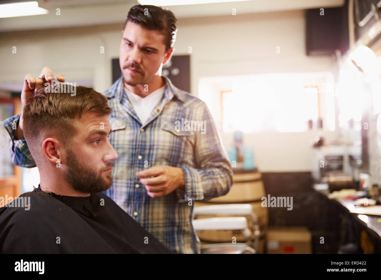 Male Barber Giving Client Haircut In Shop Stock Photo - Alamy