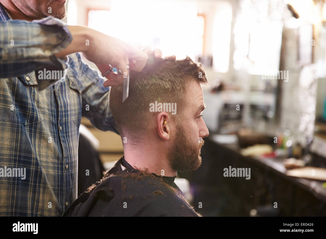 Male Barber Giving Client Haircut In Shop Stock Photo - Alamy